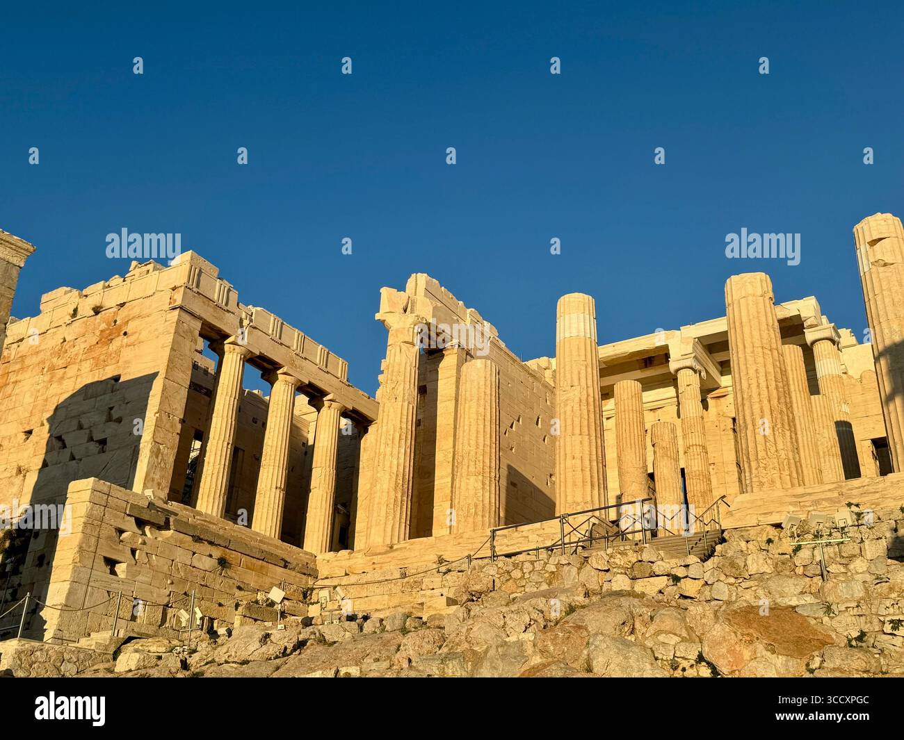 The Acropolis in Athens illuminated by the golden hour sunset, with the ...