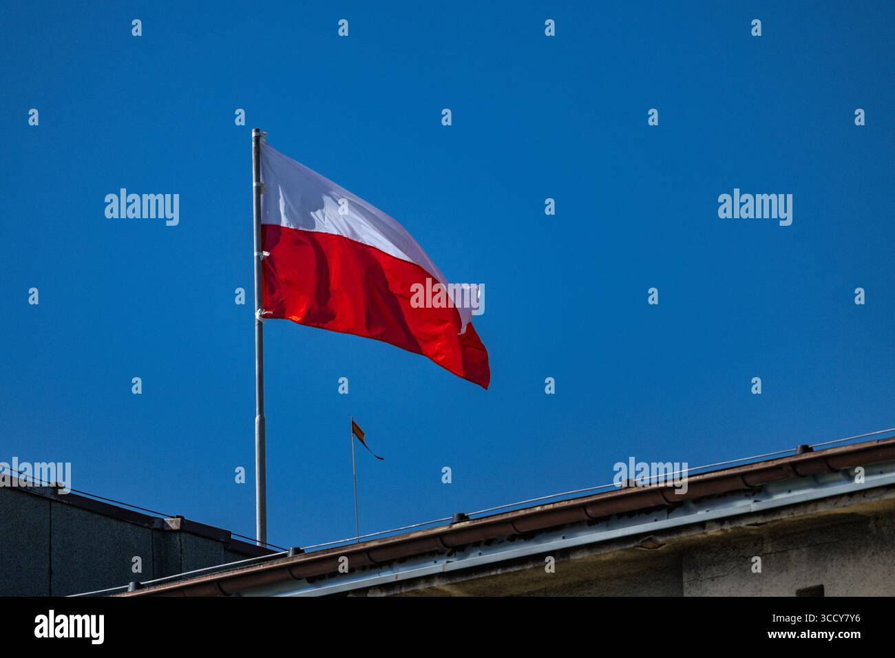 The national flag of the Republic of Poland on the roof of a public ...