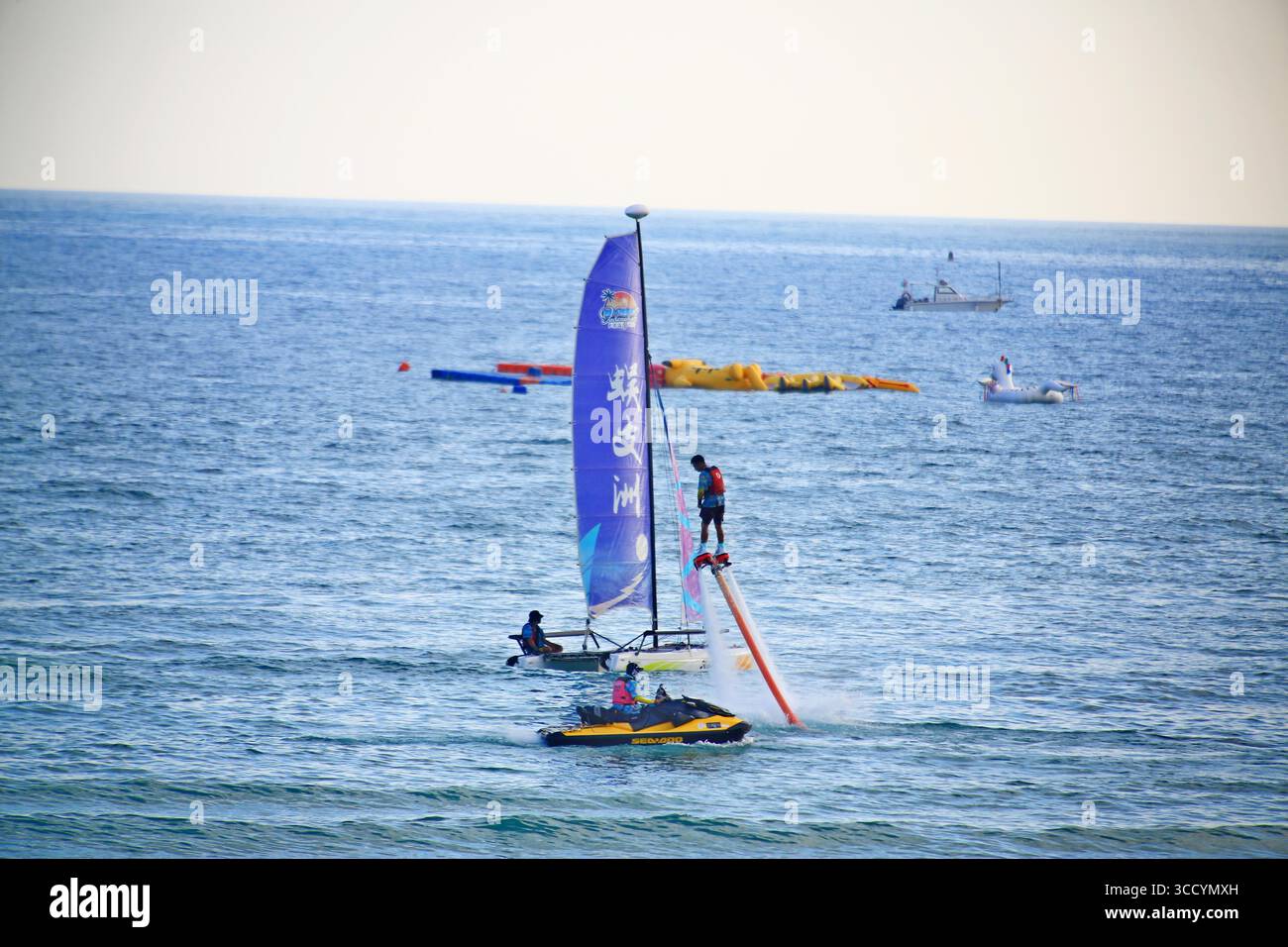 Tourists enjoy coolness at Dadonghai Bay Scenic Area in Sanya City ...