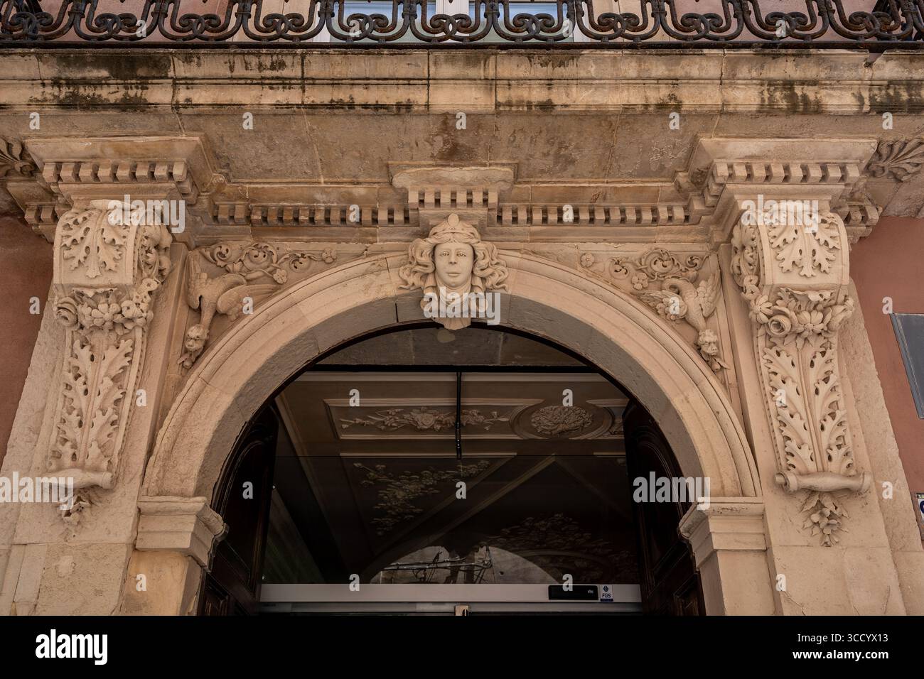 Ornate stone arch with female face carving in Siracusa, Sicily Stock ...