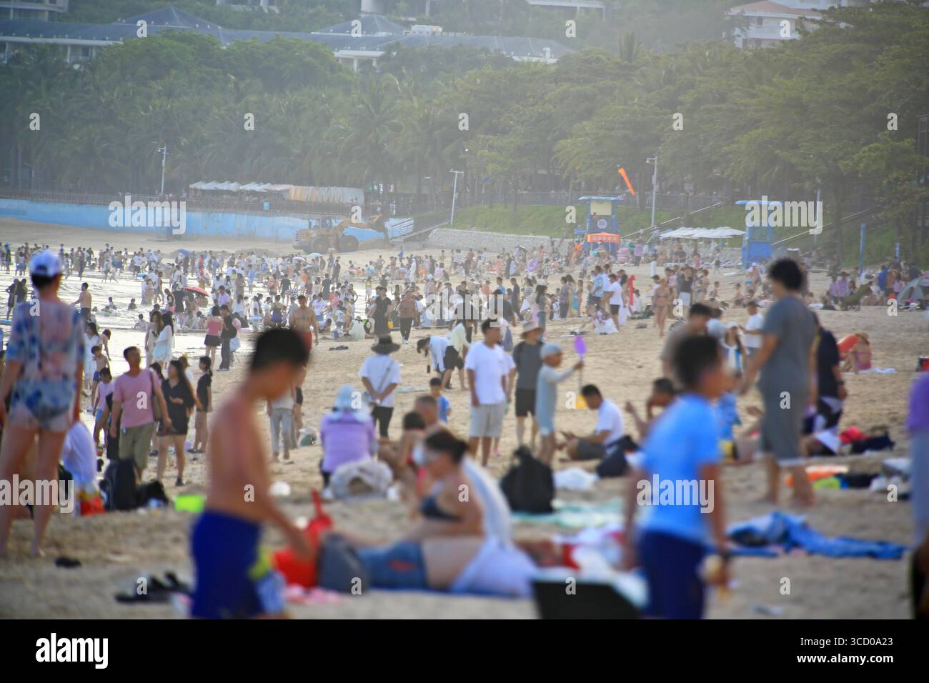 Tourists enjoy coolness at Dadonghai Bay Scenic Area in Sanya City ...