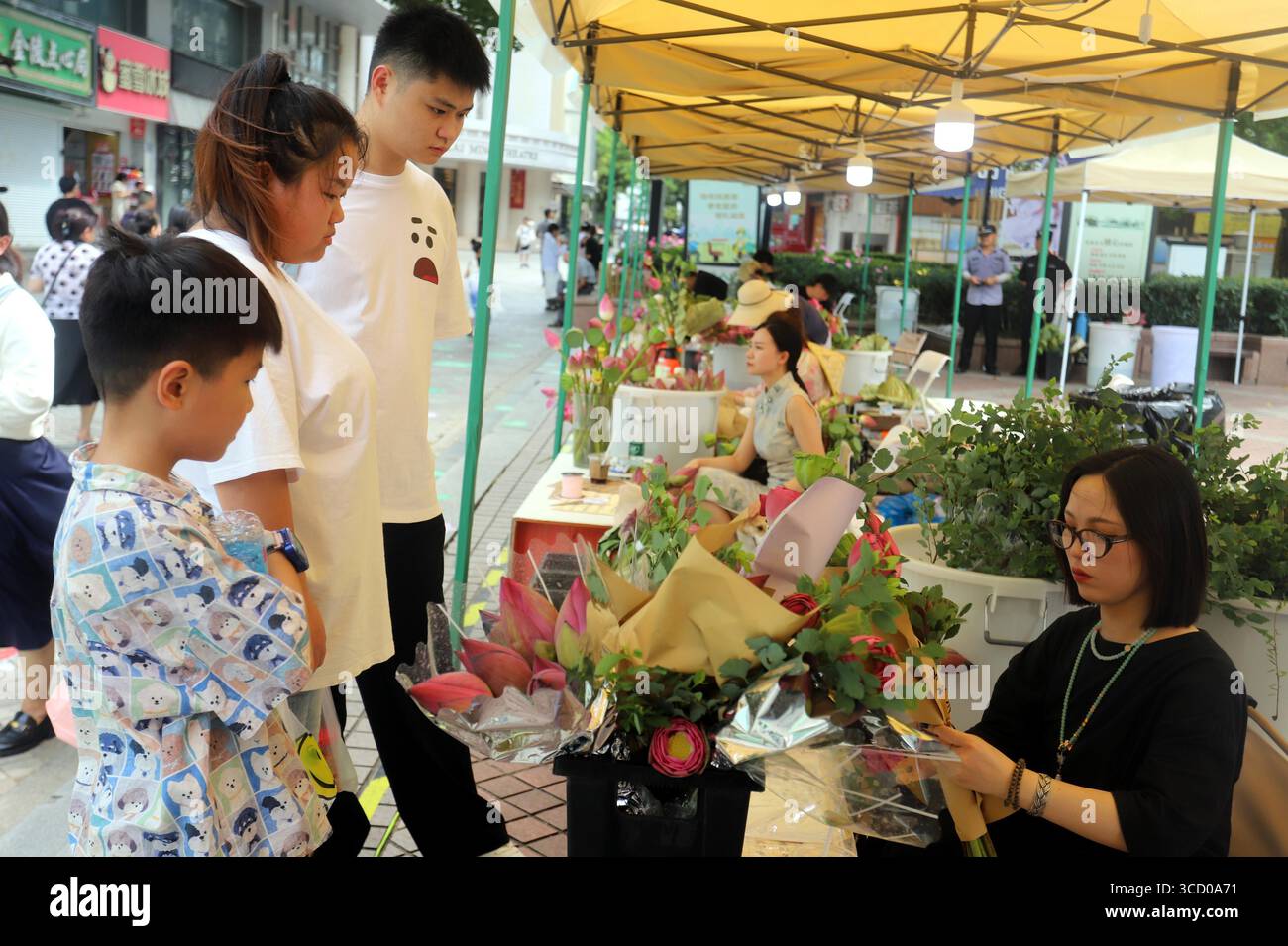 People buy lotus flowers at a lotus fair in Suzhou City, east China's ...