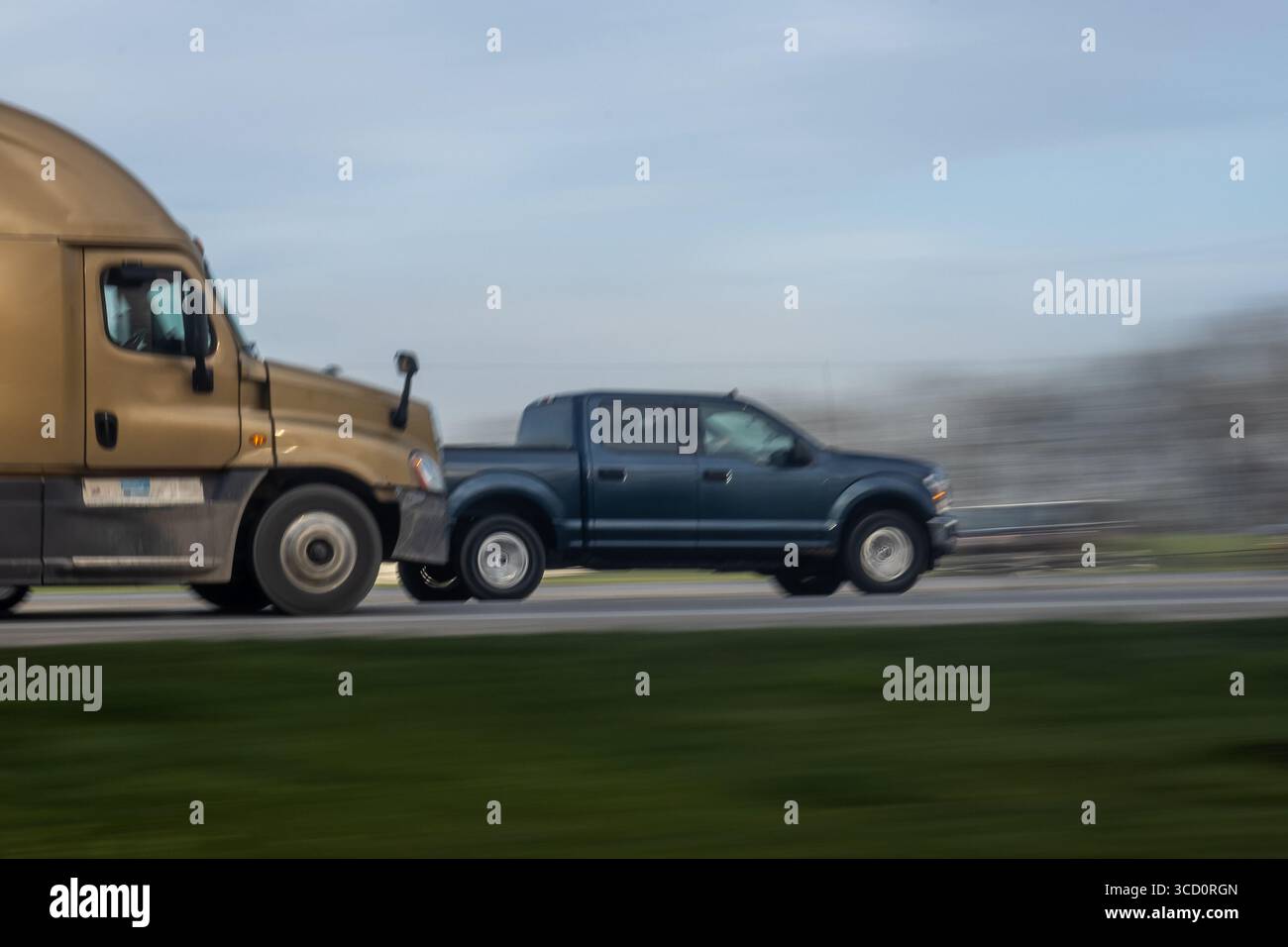 trucks driving down a road side by side Stock Photo - Alamy