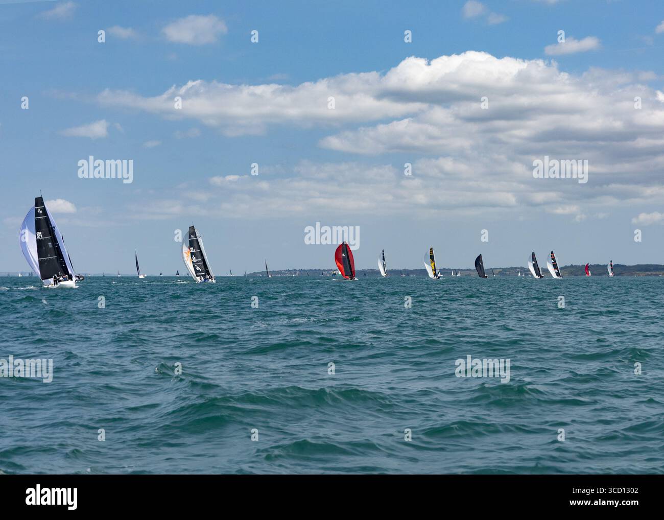A fleet of performance yachts racing under spinnakers during the 2025 ...