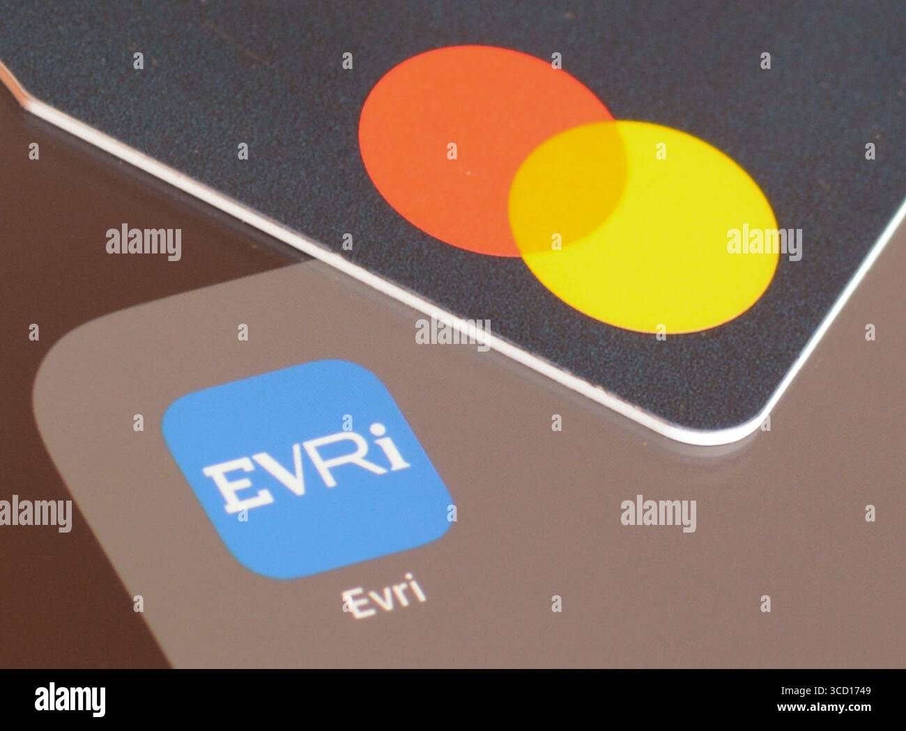 Evri parcel delivery app on smartphone screen with a Mastercard to make ...