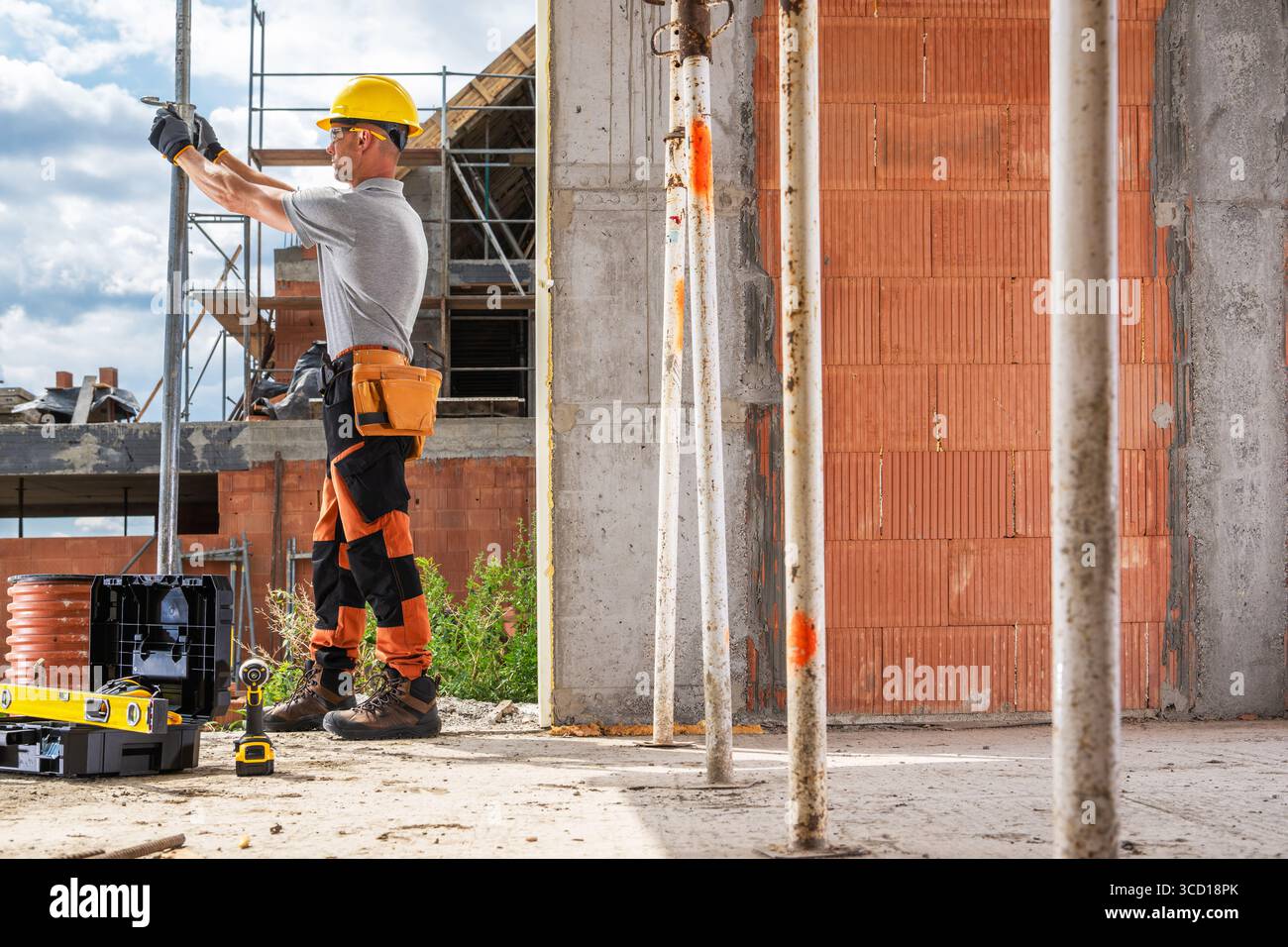 Construction worker carefully measuring hi-res stock photography and ...