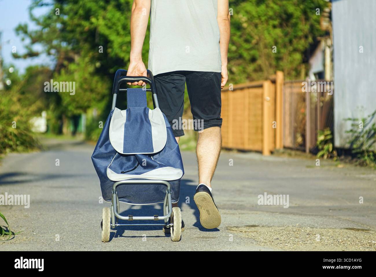 Person pulling shopping cart hi-res stock photography and images - Alamy