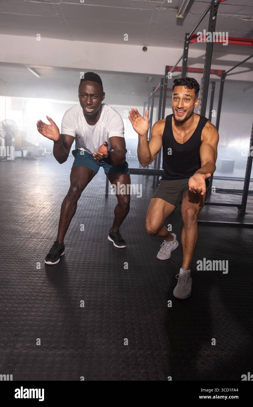 Diverse workout partners squatting hi-res stock photography and images ...