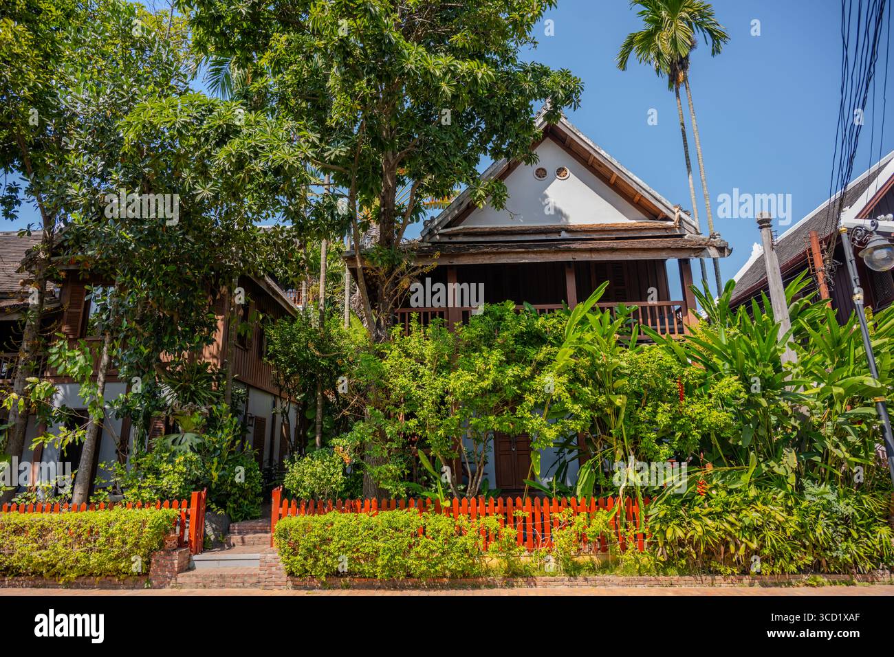 Traditional Lao Wooden House with Lush Garden and Colonial Architecture ...