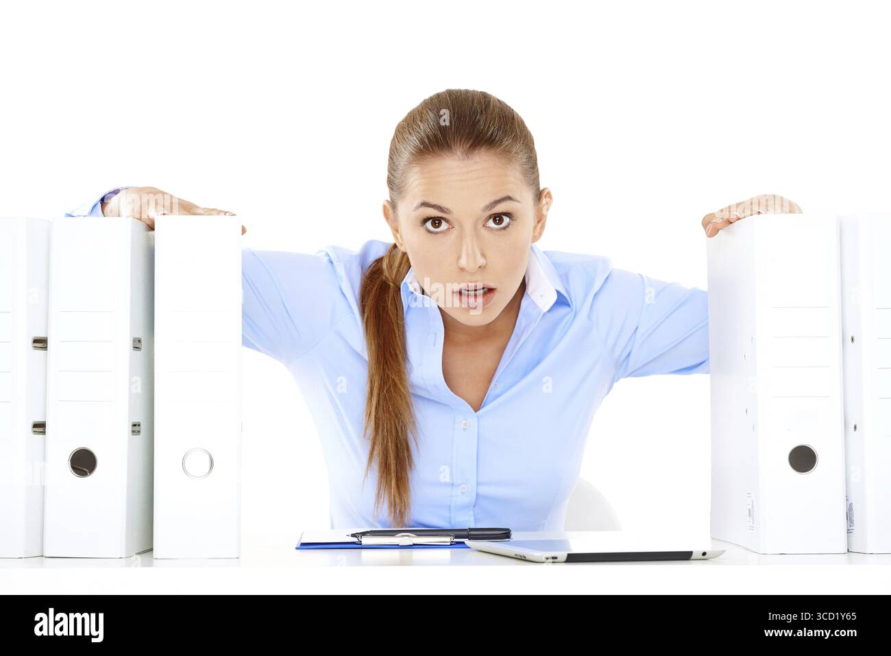 Stressed young businesswoman staring at the camera from between two ...