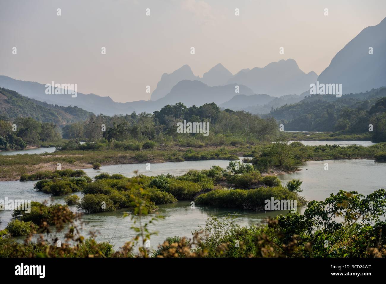 Scenic view of Nam Ou River winding through lush forest and karst ...
