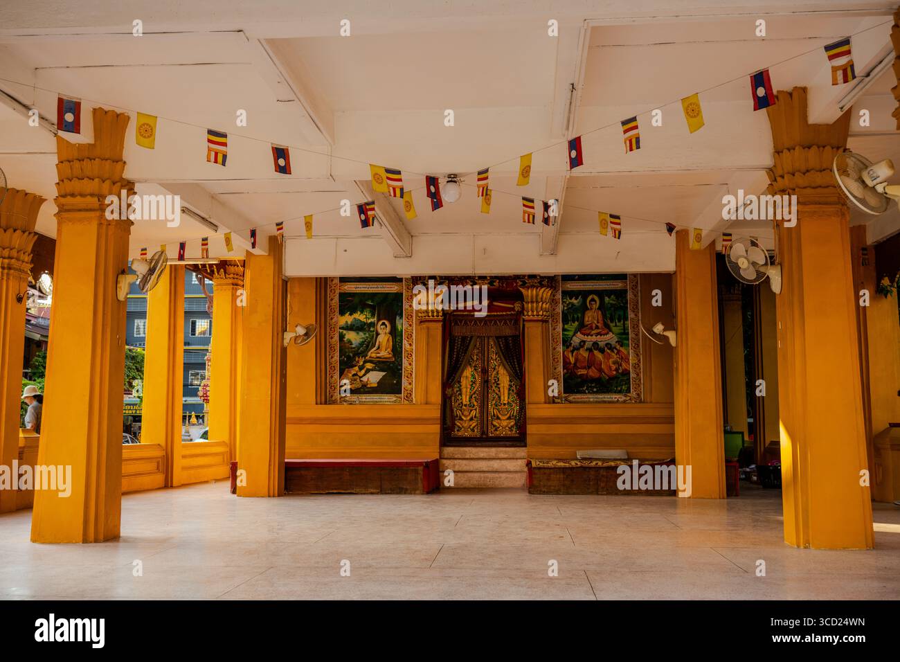 Interior view of a Buddhist temple in Vientiane, Laos. The vibrant ...