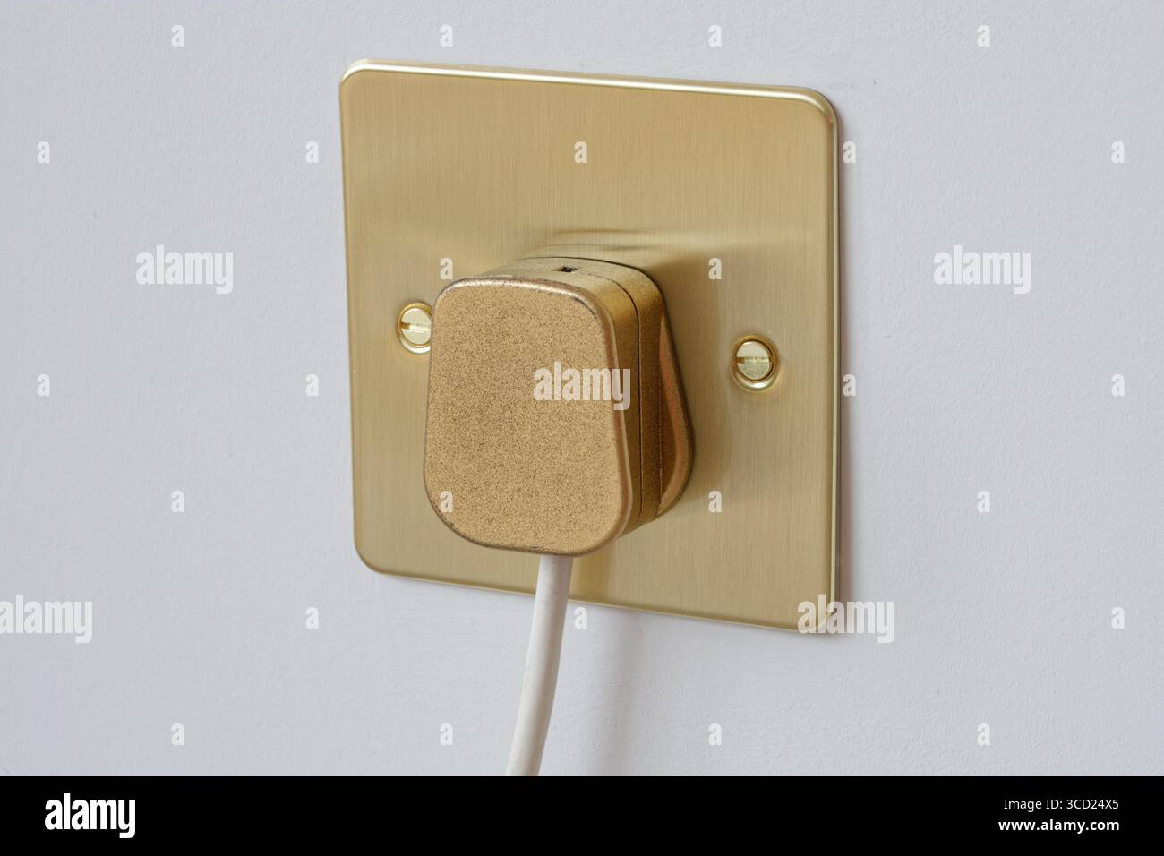 Brushed brass surface of a 5 amp electrical socket in the United ...