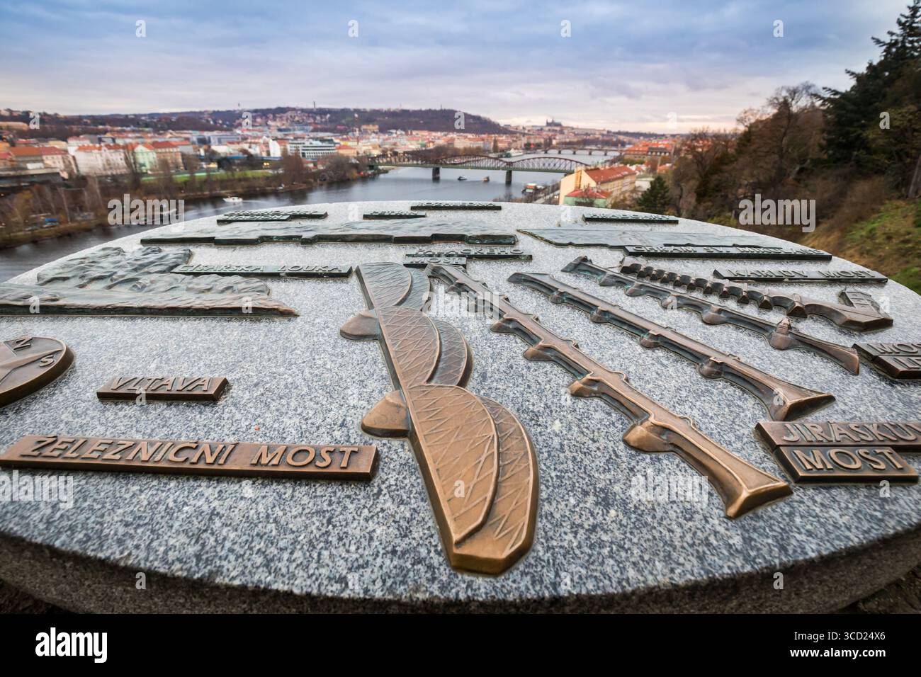 View of stone and metal Prague map with castle, Vltava river and ...