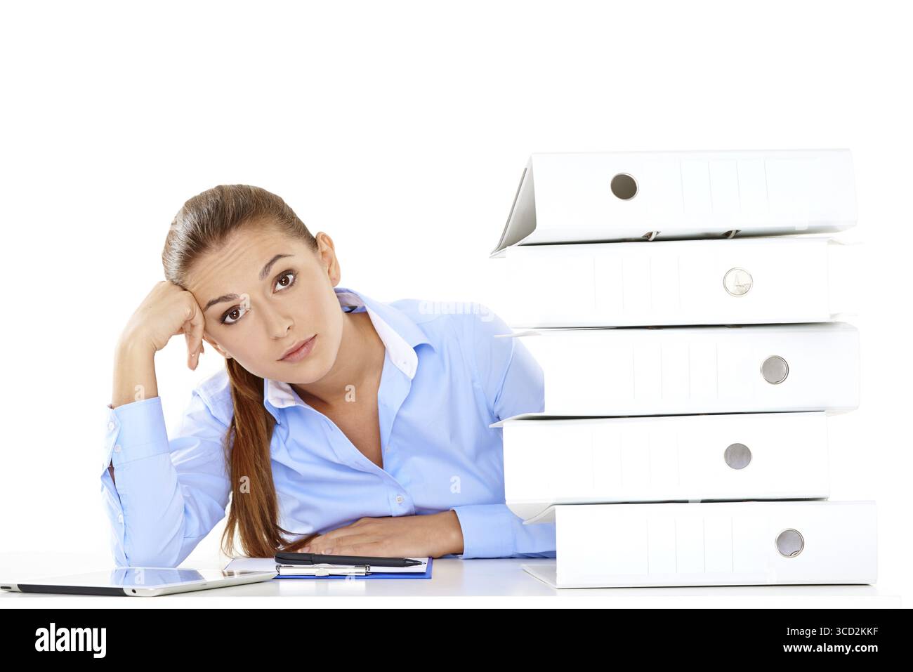Overworked stressed young businesswoman staring at the camera with her ...