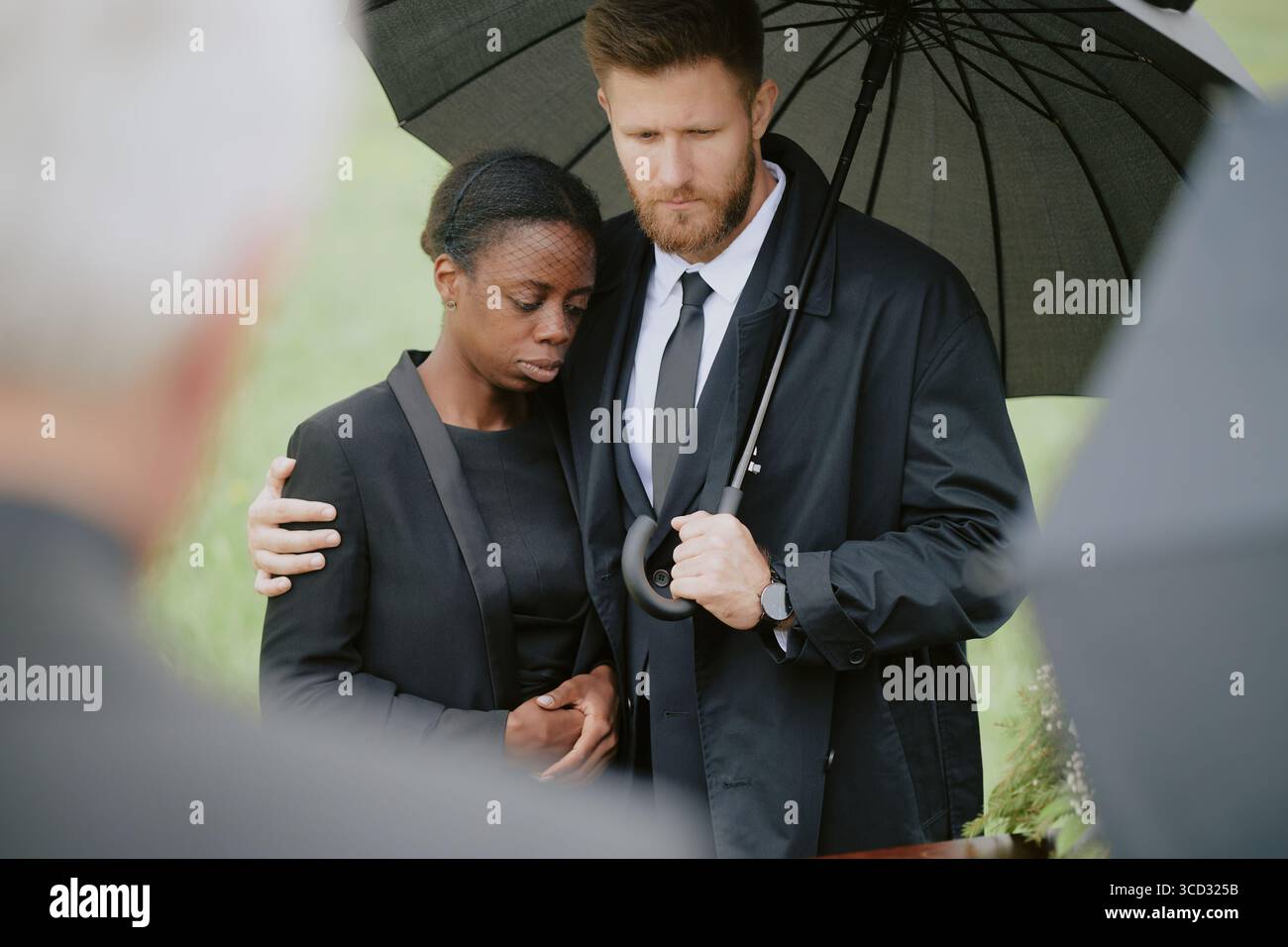 Caucasian middle aged man comforting Black young adult woman under ...