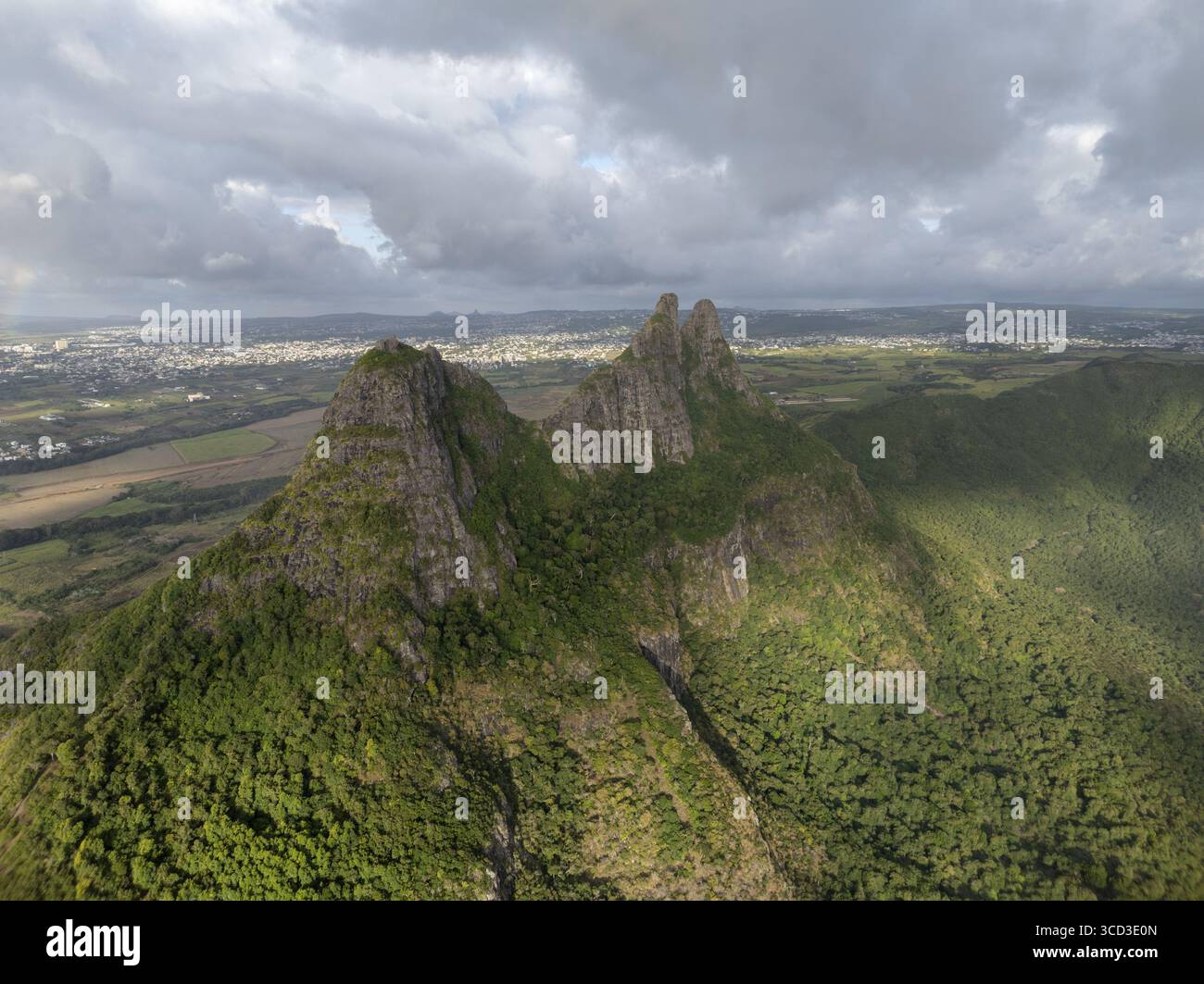 Aerial view of lush mountain landscape with greenery and cloudy sky ...