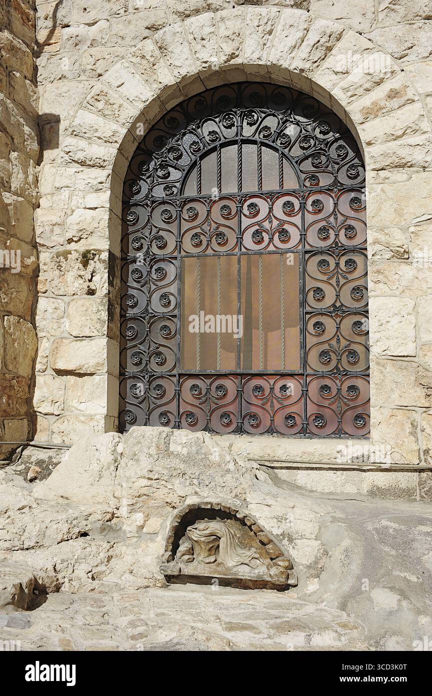 Sculpture of crying Christ in a stone niche in the Garden of Gethsemane ...