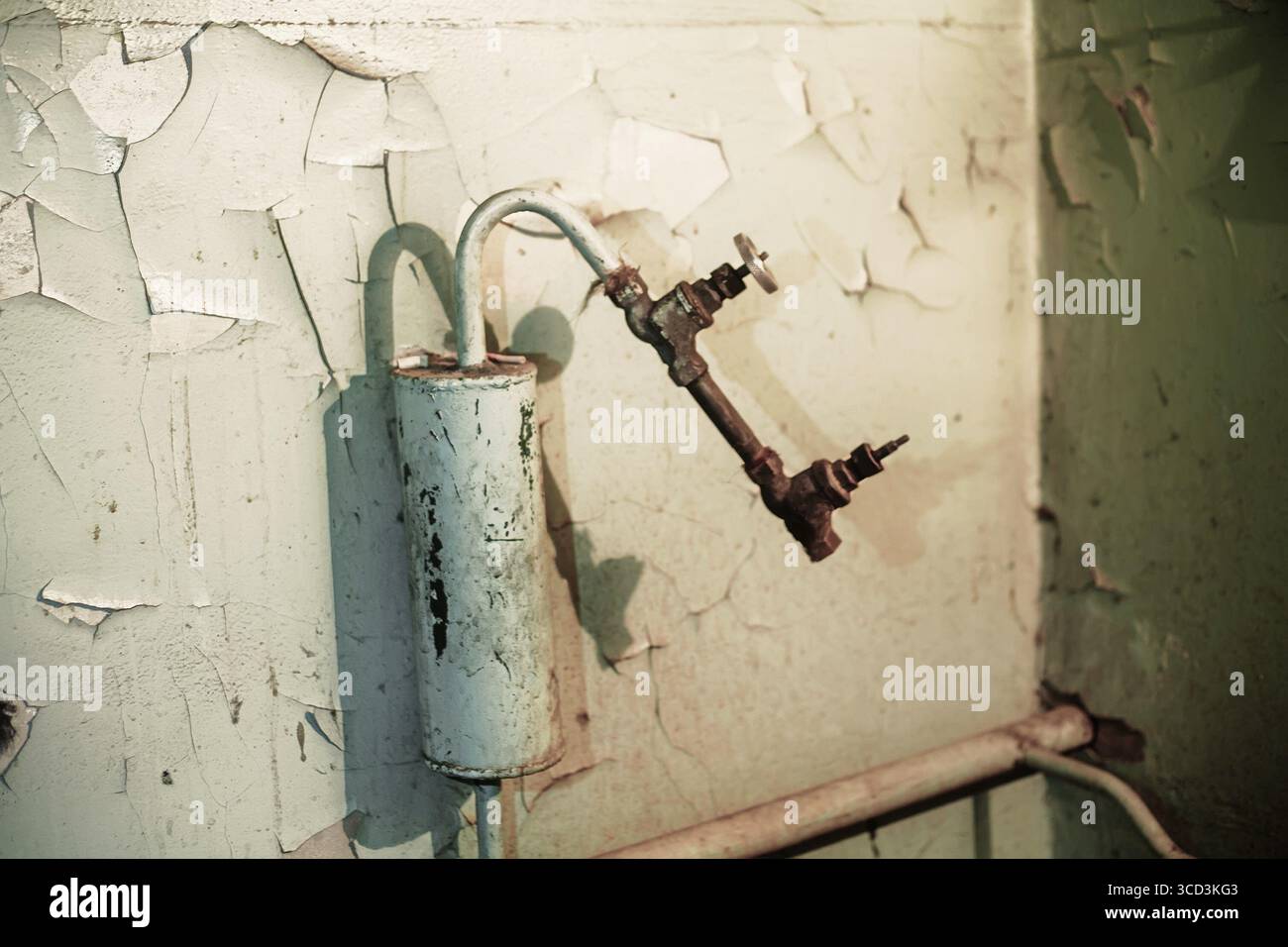 Old expansion tank and rusty hot water pipe Stock Photo - Alamy
