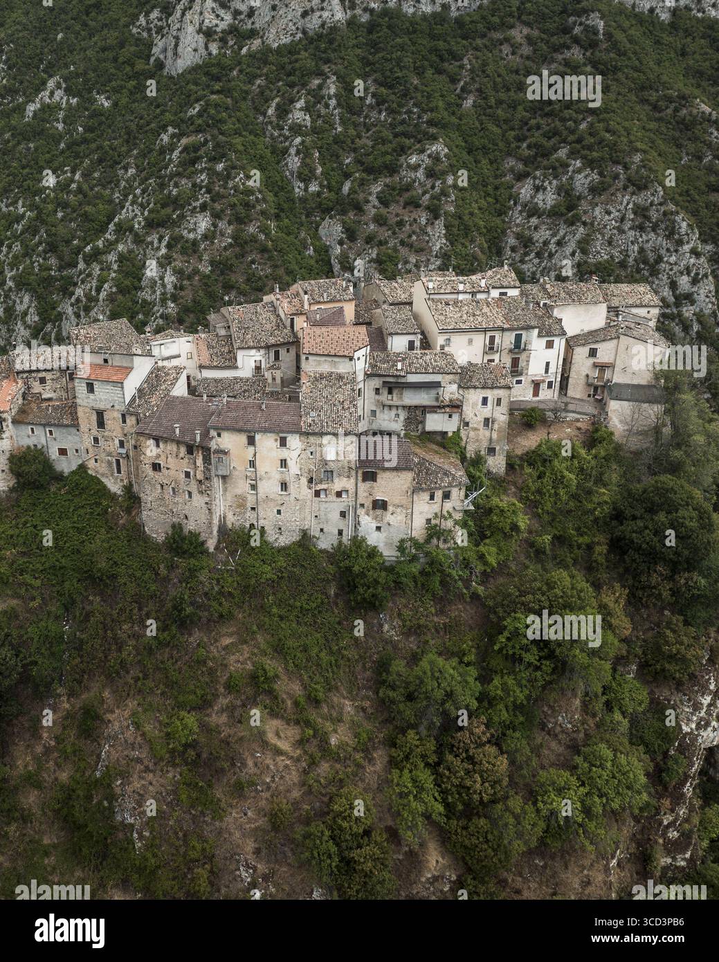 Aerial view of ancient stone buildings clustered tightly on a steep ...