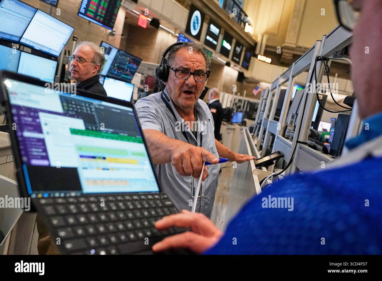 Options trader Frank Maiolo, center, works on the floor of the New York ...
