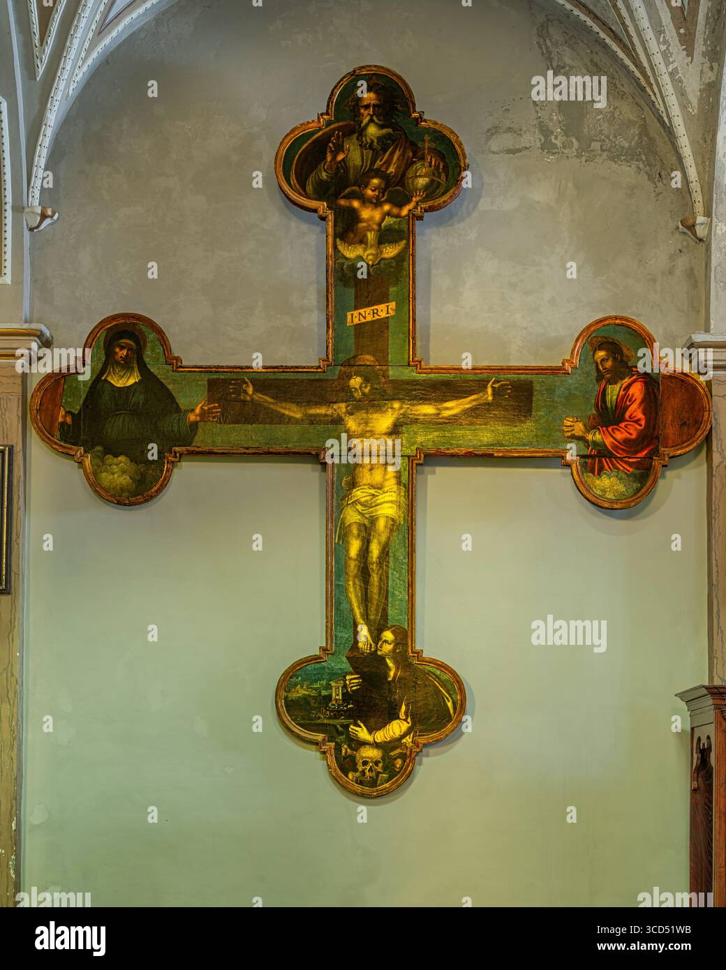 A painted wooden medieval crucifix depicting the Crucifixion scene with ...