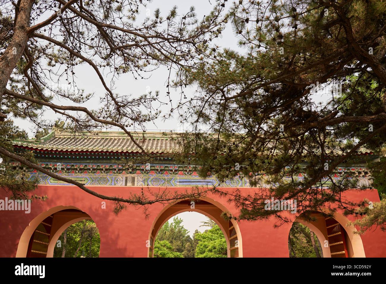 Traditional Chinese architecture with red walls and arched gateways ...