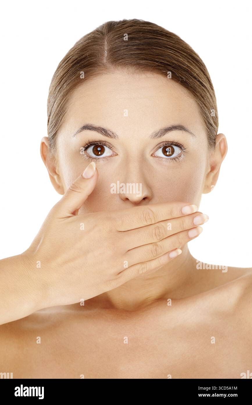 Woman with a shocked expression staring wide eyed at the camera with ...