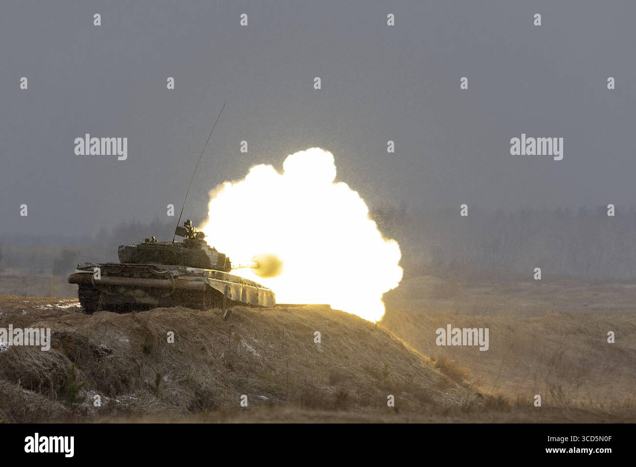 Fire and smoke from a tank shot during training at the training ground ...
