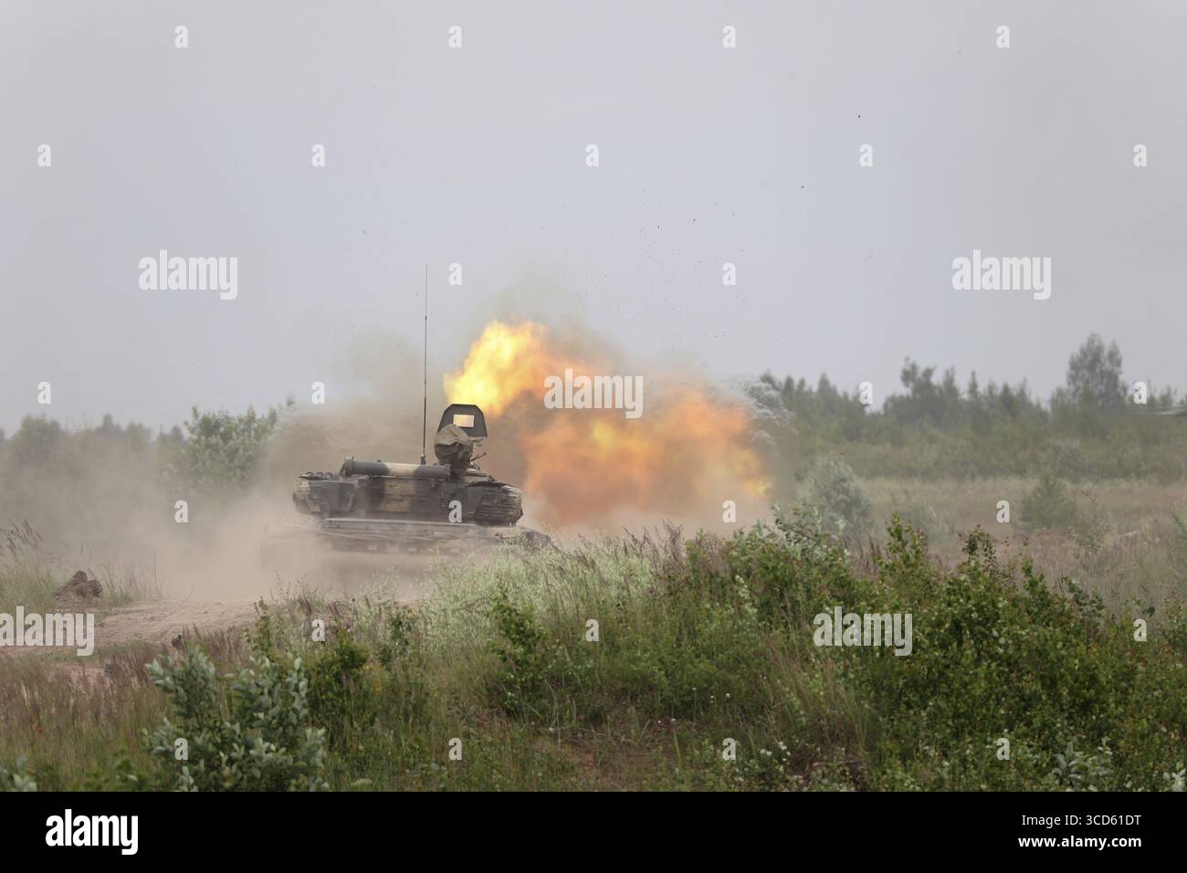 Fire and smoke from a tank shot during training at the training ground ...