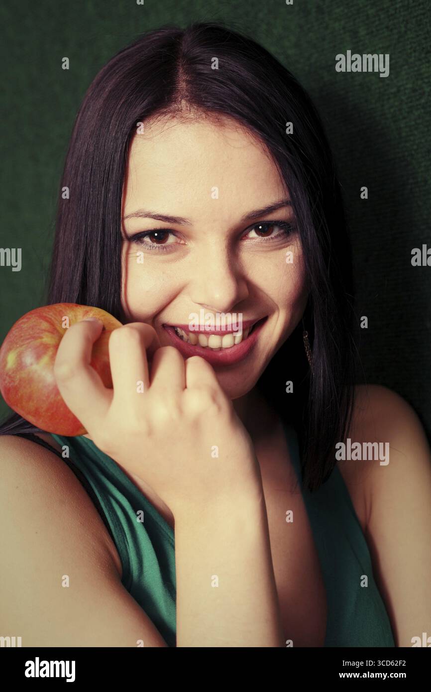 Women apple near face hi-res stock photography and images - Alamy