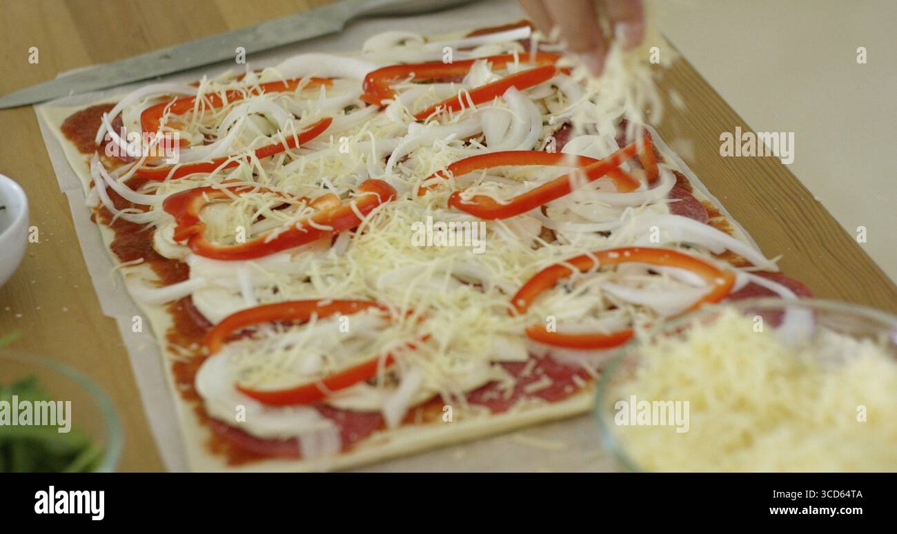 Woman make a tasty traditional homemade Italian pizza with tomato paste ...