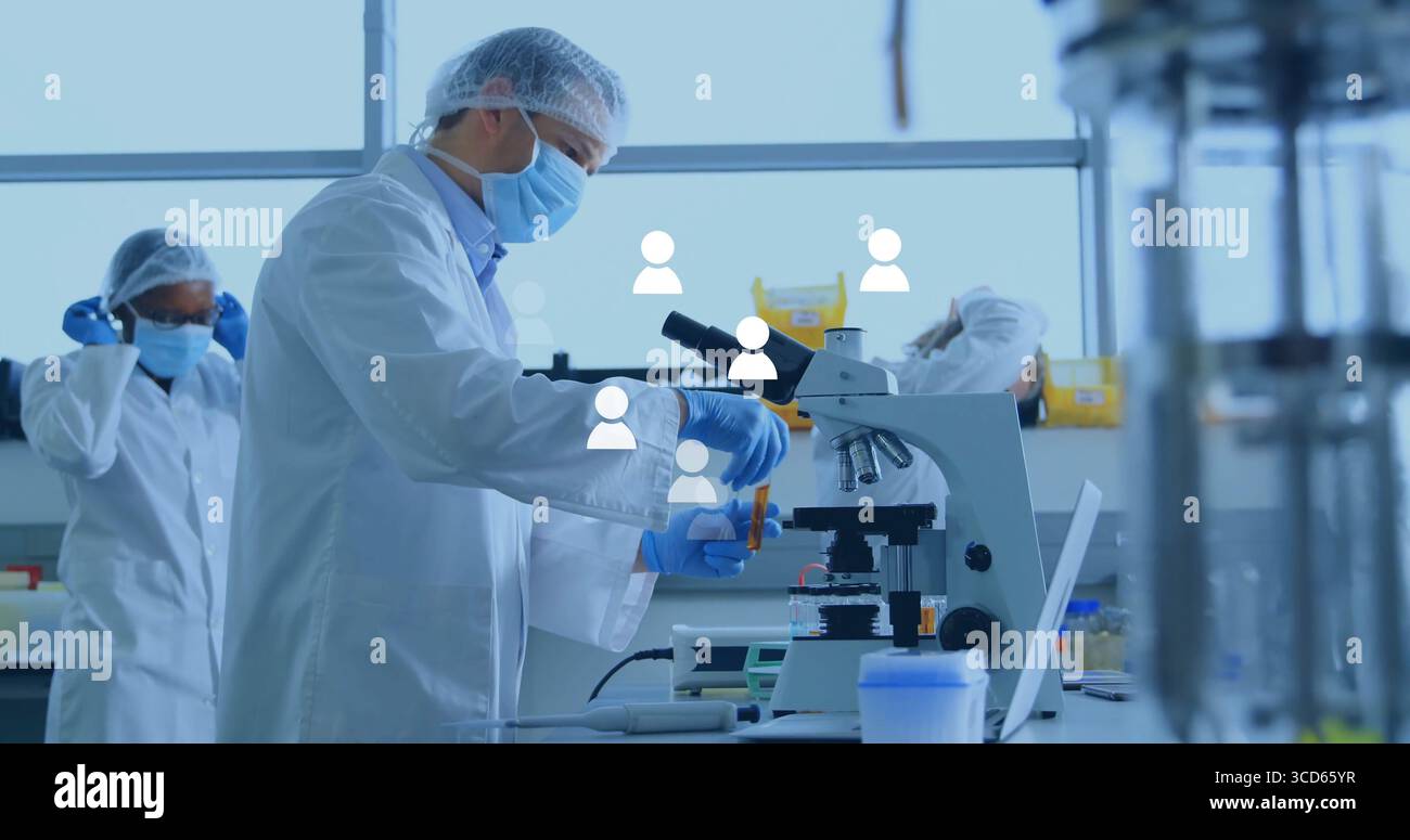 Adult scientist using pipette at lab, wearing lab coat, with microscope ...