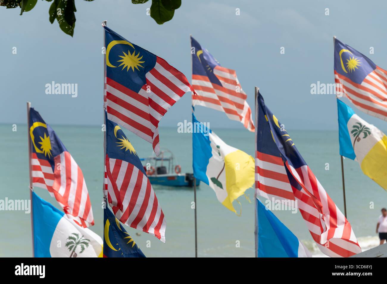 A host of the national flag of Malaysia on Batu Ferringhi on the ...
