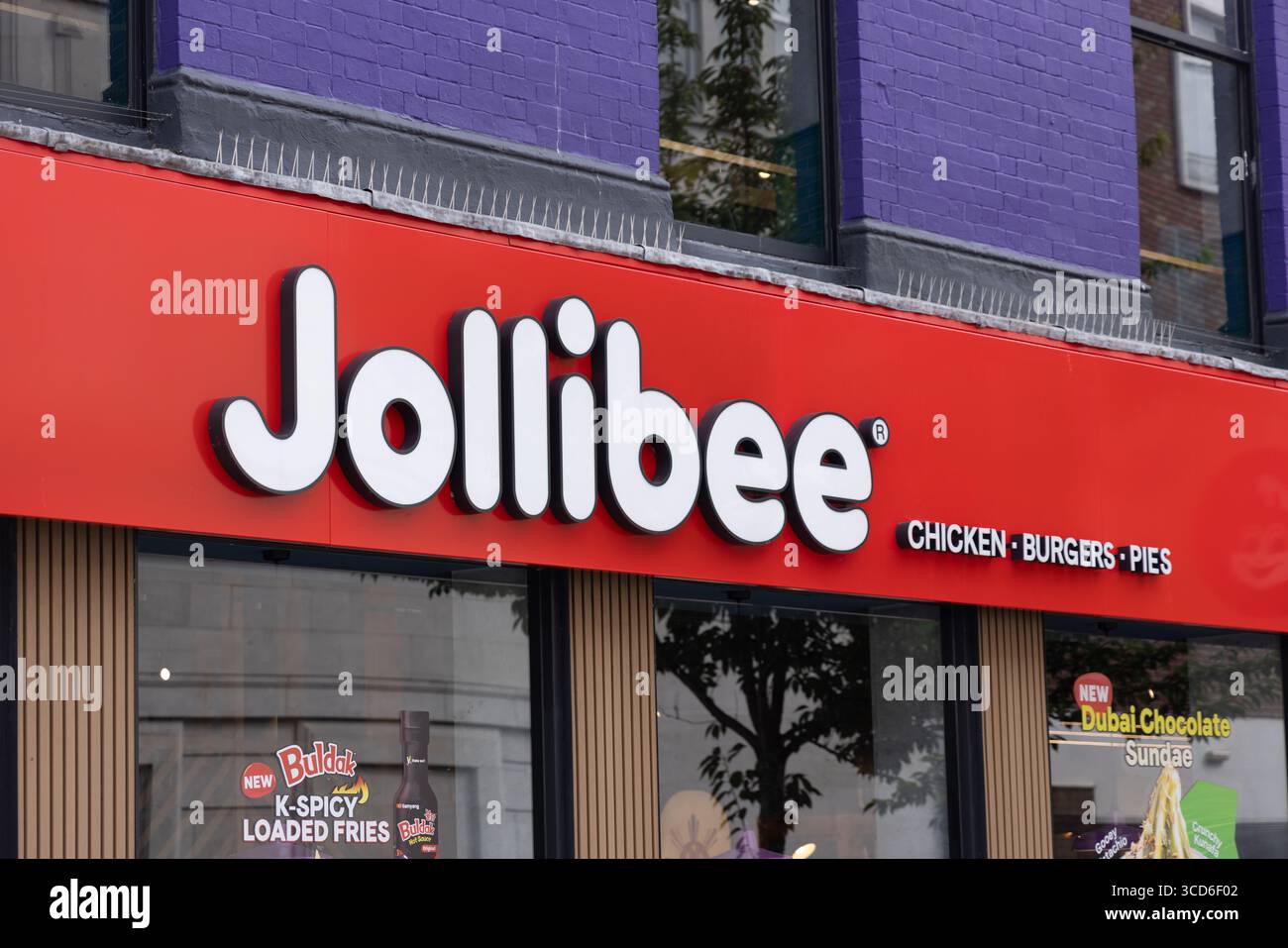 CARDIFF, UK - AUGUST 8, 2025 - Red Jollibee sign and storefront in ...