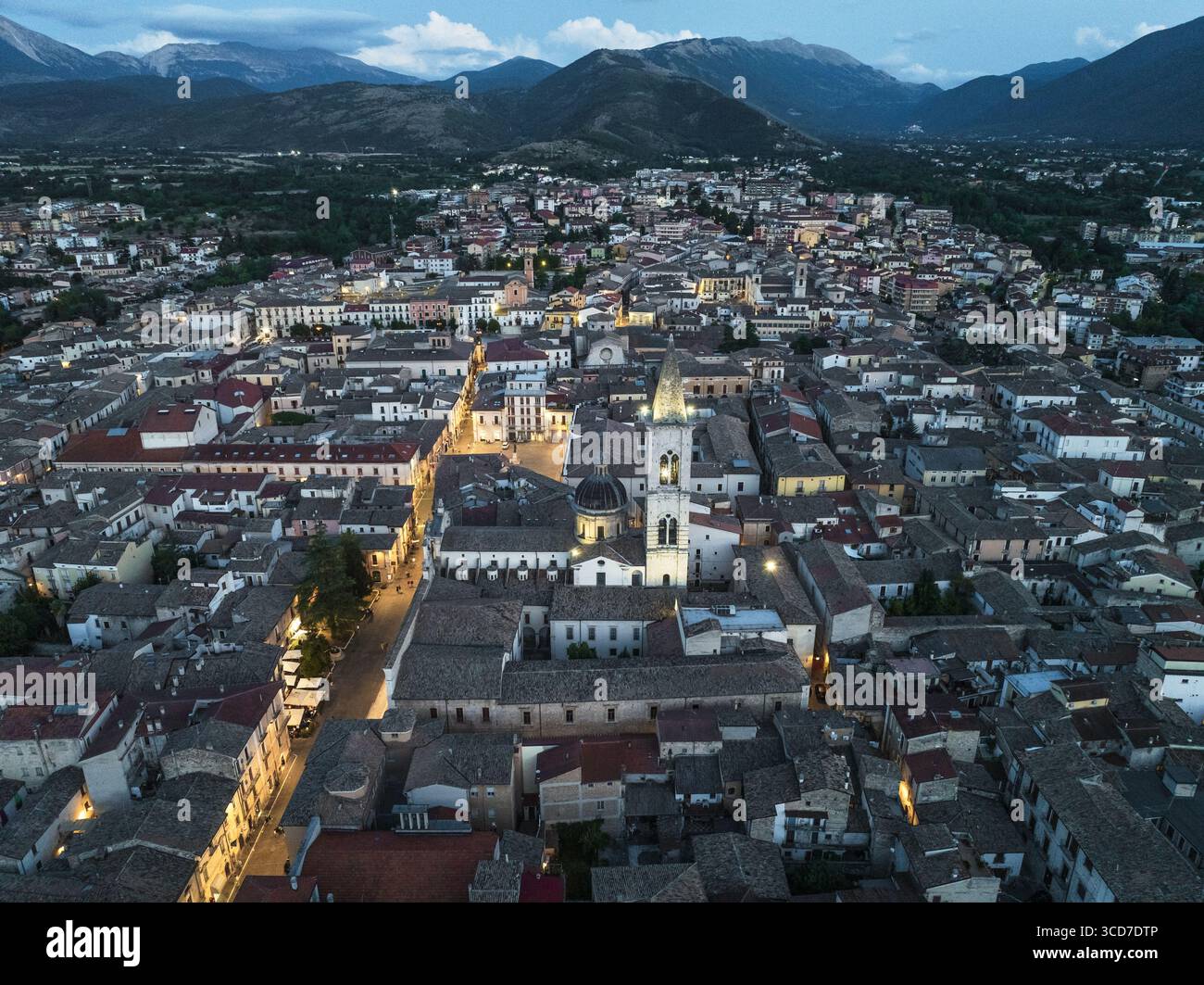 Aerial view of the illuminated Sulmona Cathedral and the Annunziata complex nestled among the ...