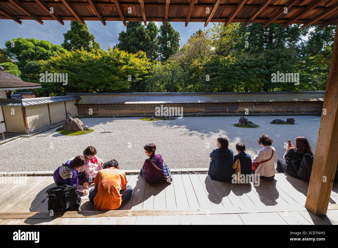 Tourist sitting on viewing platform overlooking symbolically arranged ...