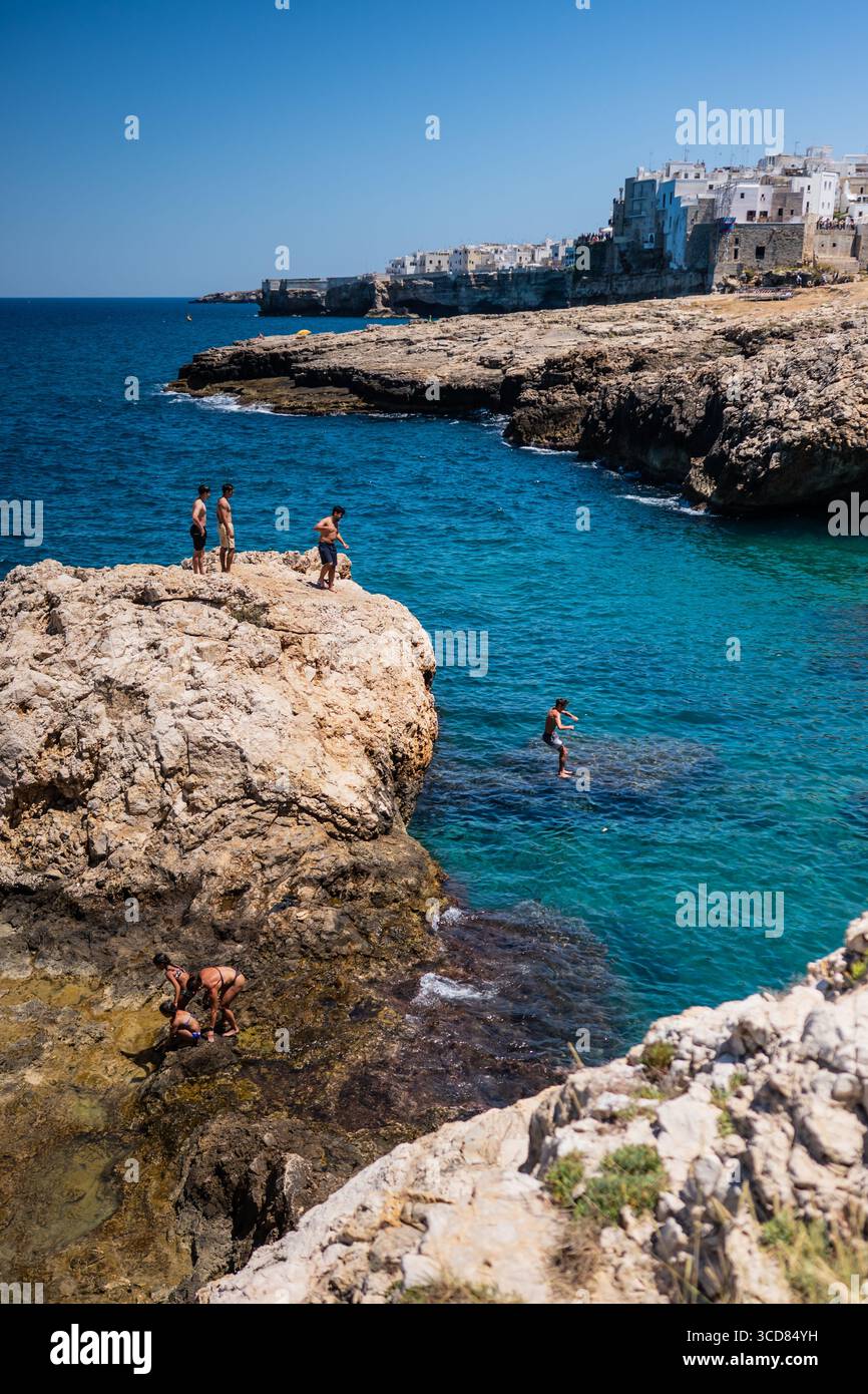 Group of people enjoying a summer swim in Polignano a Mare, Puglia ...