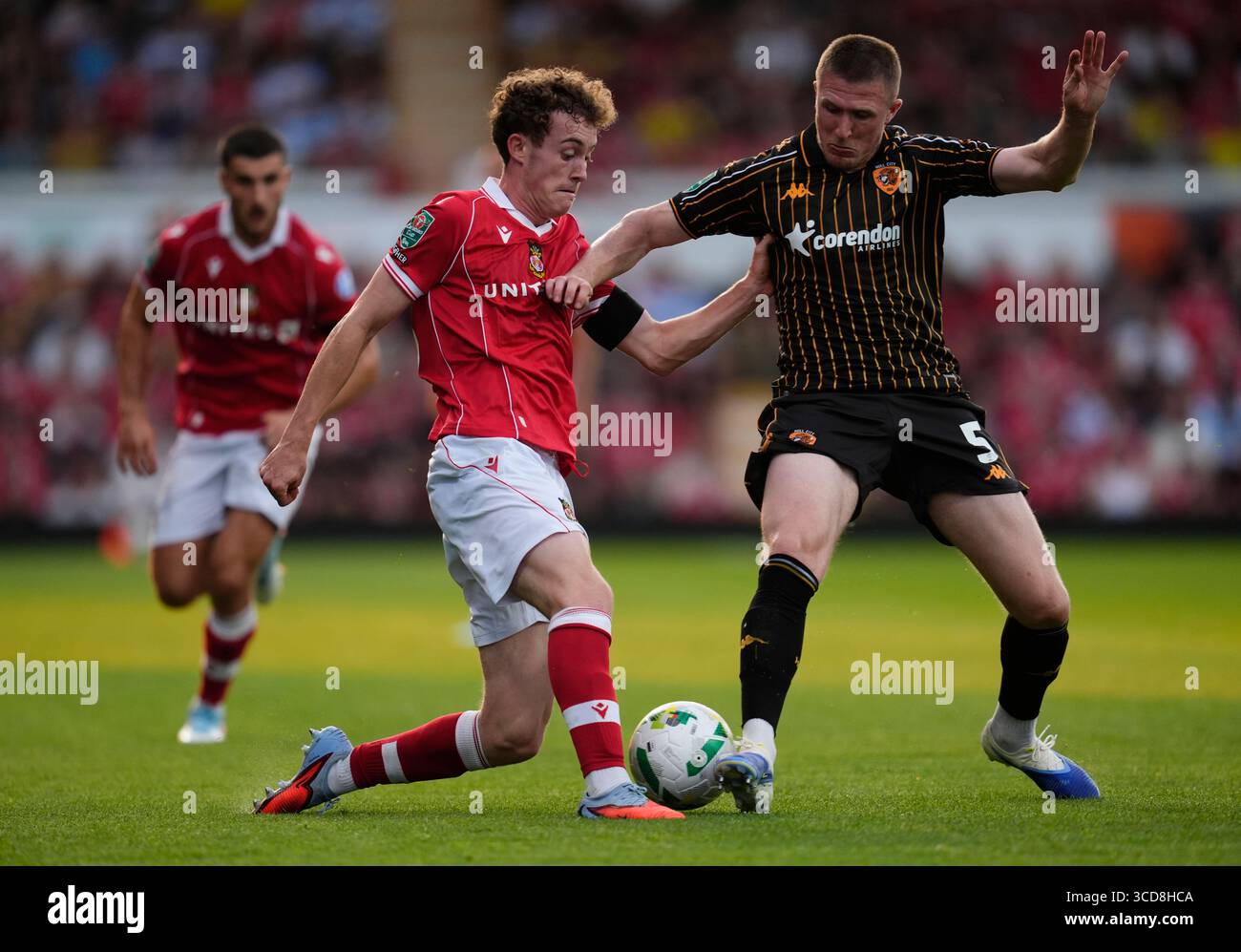 Wrexham's Harry Ashfield and Hull City's John Lundstram battle for the ...