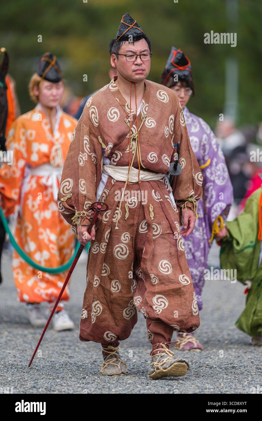 Japanese men dressed in Kamakura Period attire walking in procession of ...