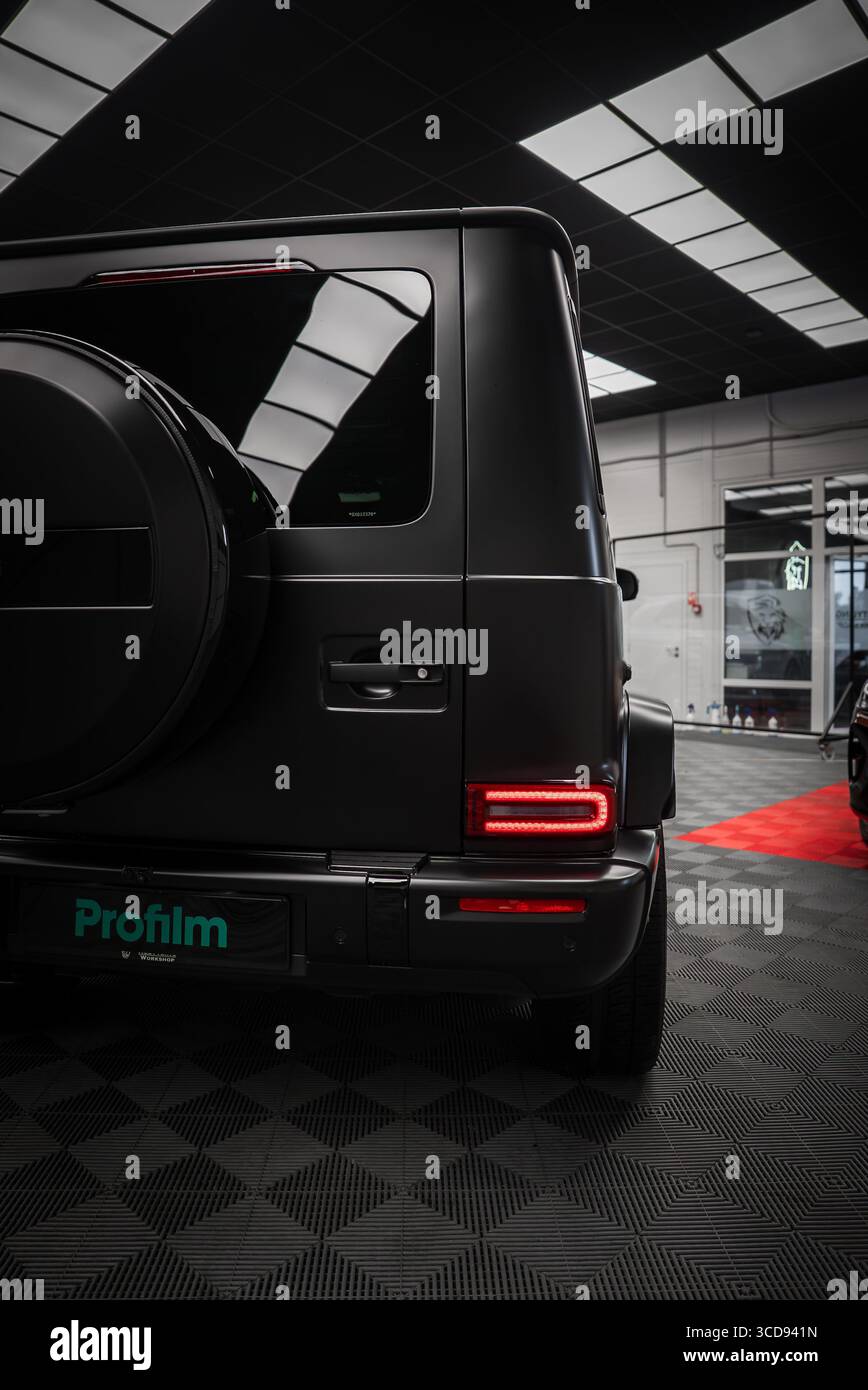 Rear View of Matte Black Mercedes AMG G Class in Showroom Setting Stock ...