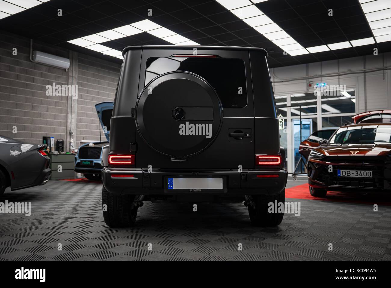 Rear View of Matte Black Mercedes AMG G Class in Modern Showroom Stock ...