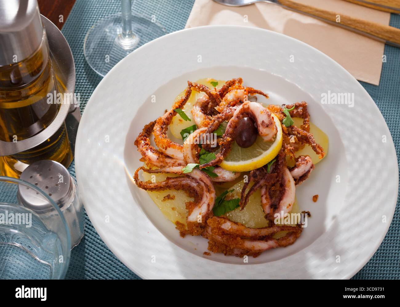 Roasted squid legs with lemon Stock Photo - Alamy