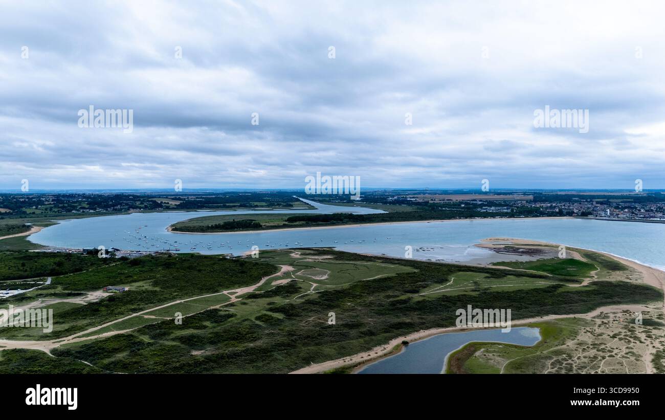 Coastal scenery with river, green islands, and overcast sky Stock Photo ...