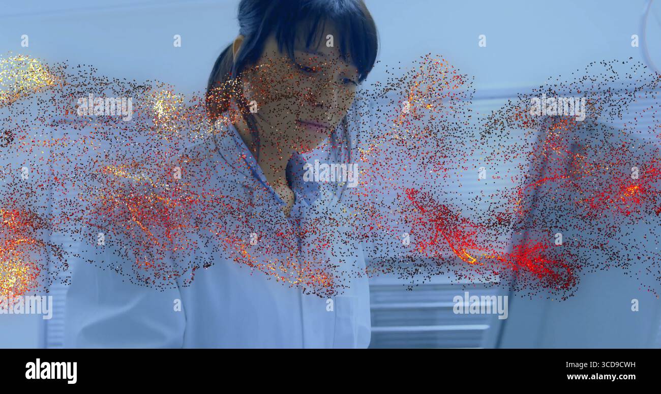 Examining holographic red and gold particle projection, researcher in ...