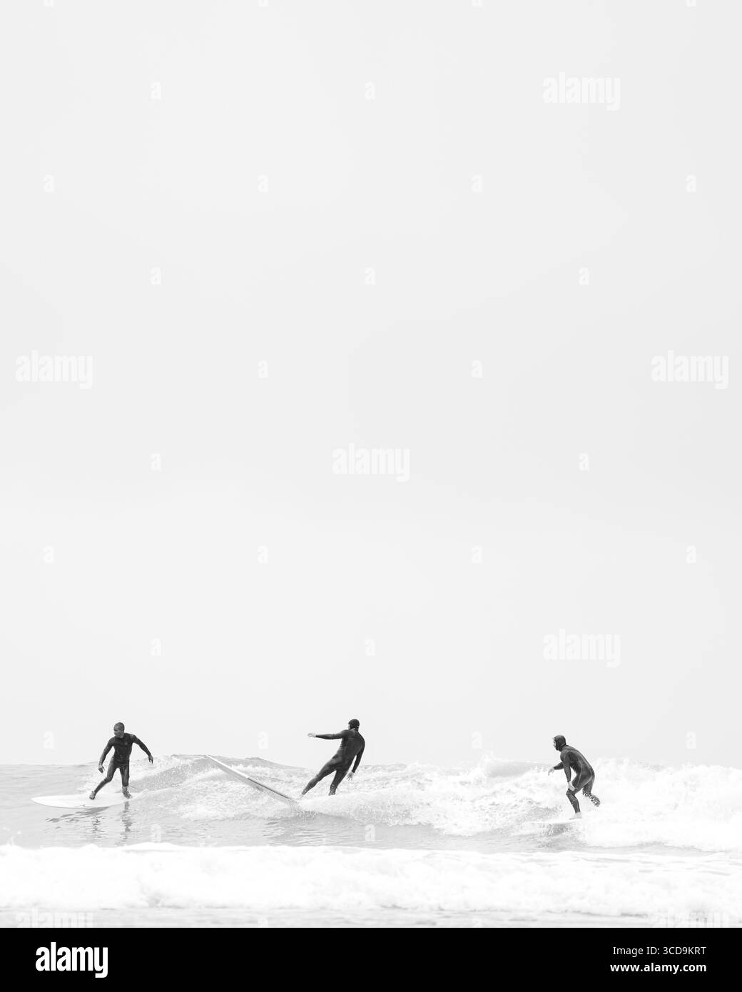 Three Surfers on One Wave Stock Photo - Alamy