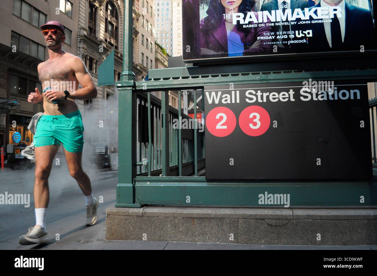 A person jogs past the Wall Street subway station as steam rises from ...