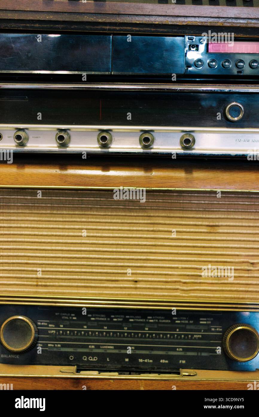 A view of very colorful antique broadcast radios from different eras ...