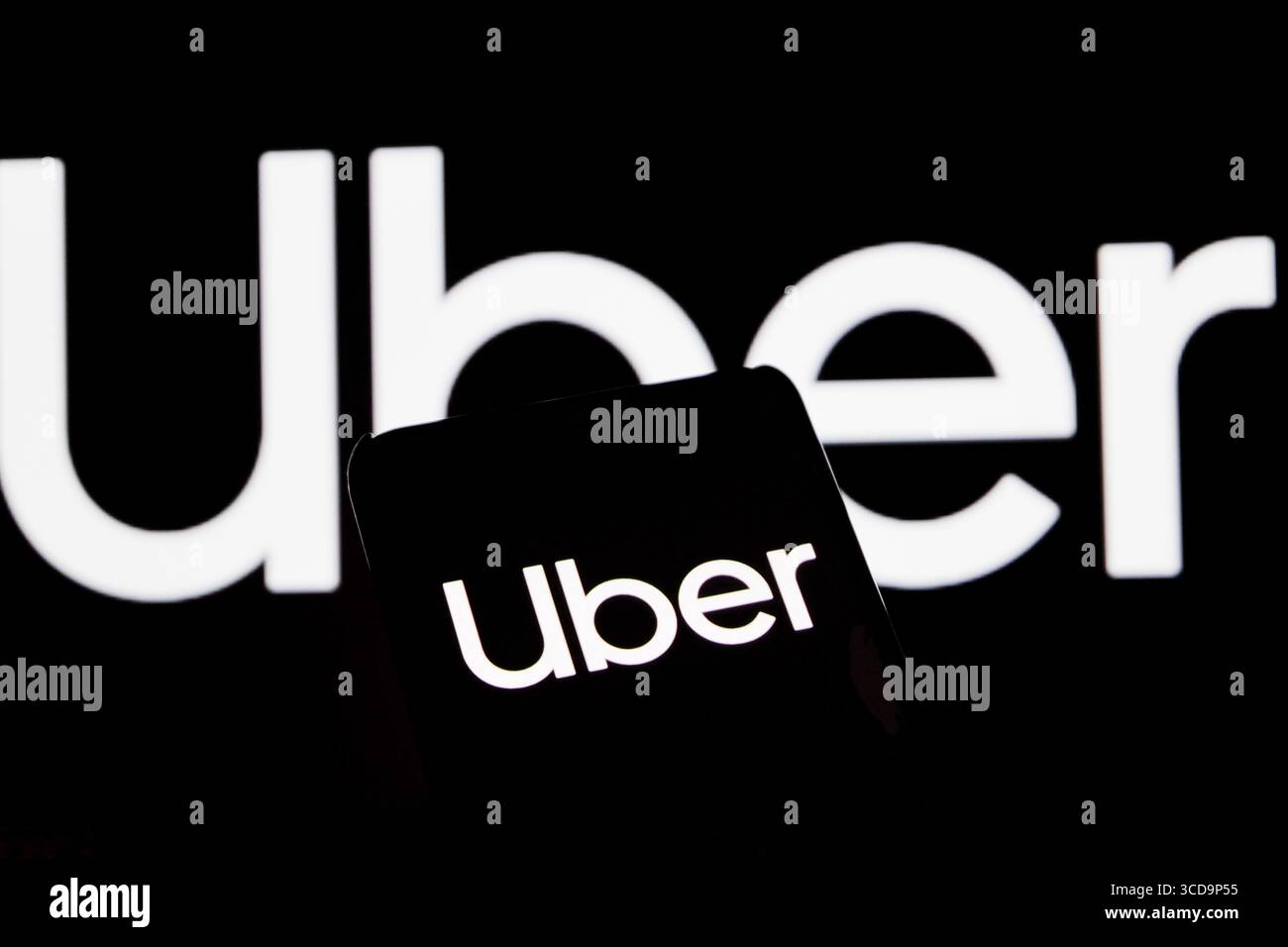 In this photo illustration, The Uber logo is seen displayed on a mobile ...