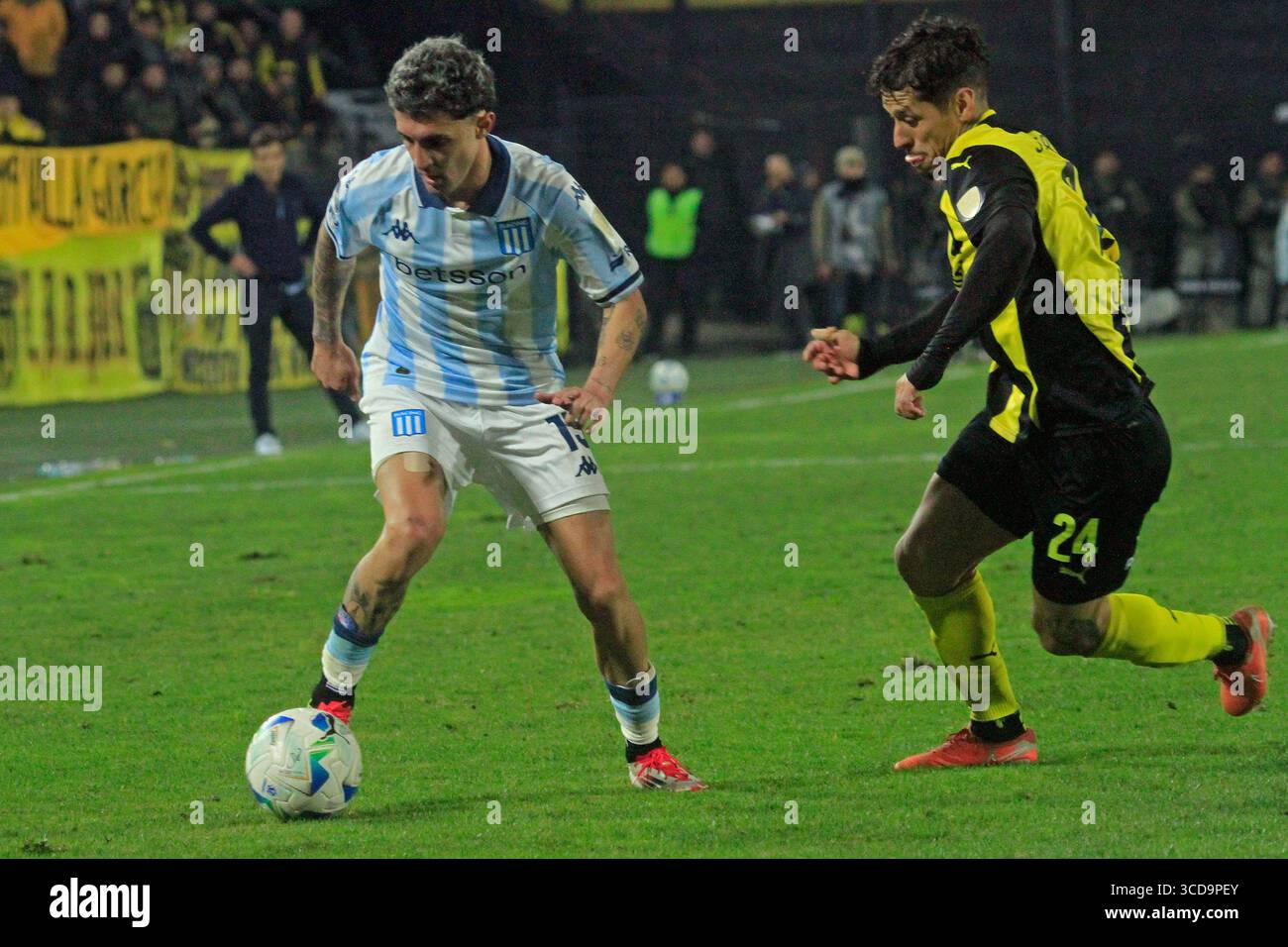 Montevideo, Uruguay, 12th Aug, 2025. Jesus Trindade of Penarol battles for possession with ...